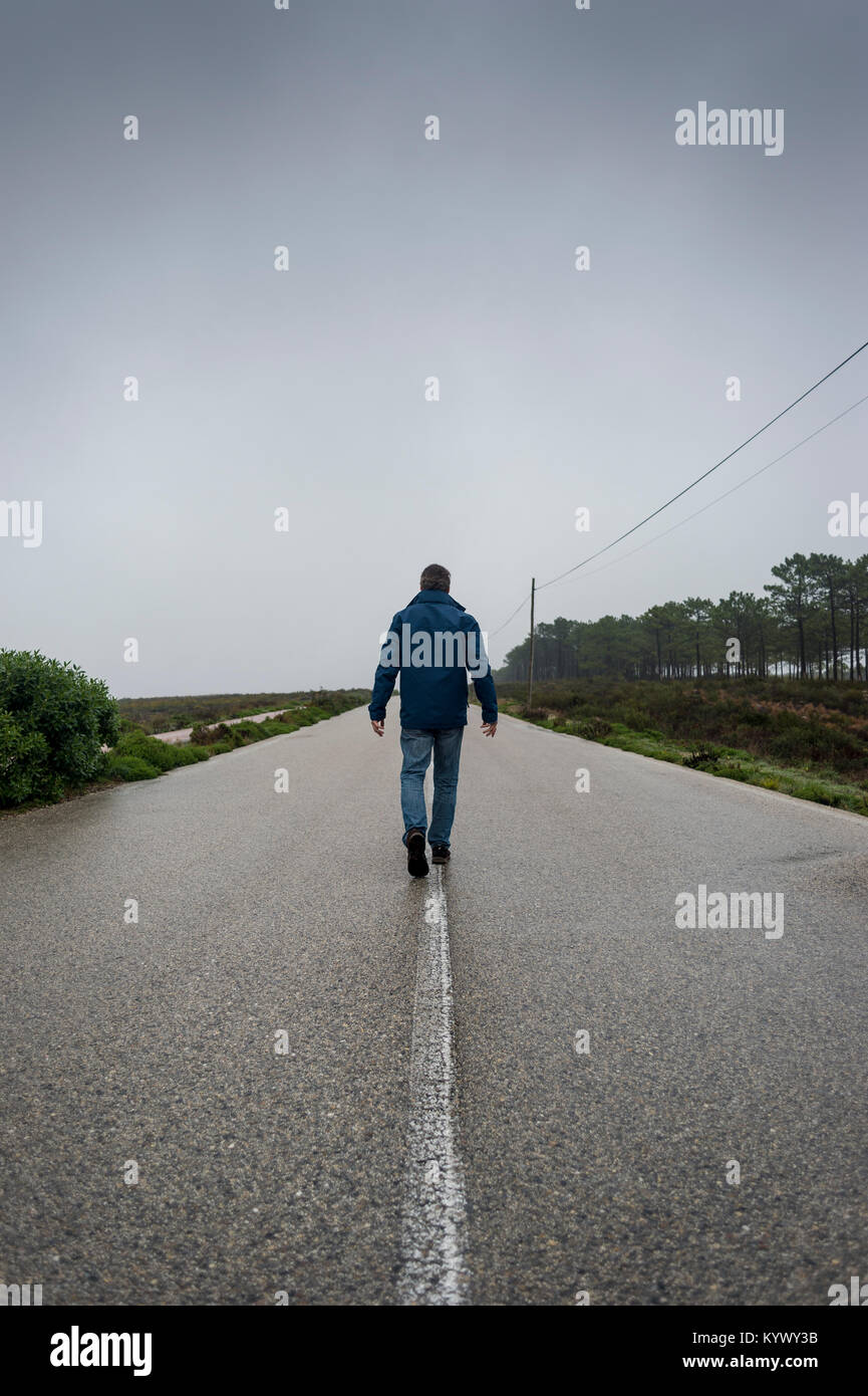 Man walking lonely road hi-res stock photography and images - Alamy