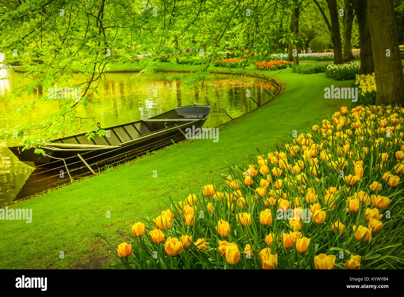 spring garden with canal and boat Stock Photo - Alamy