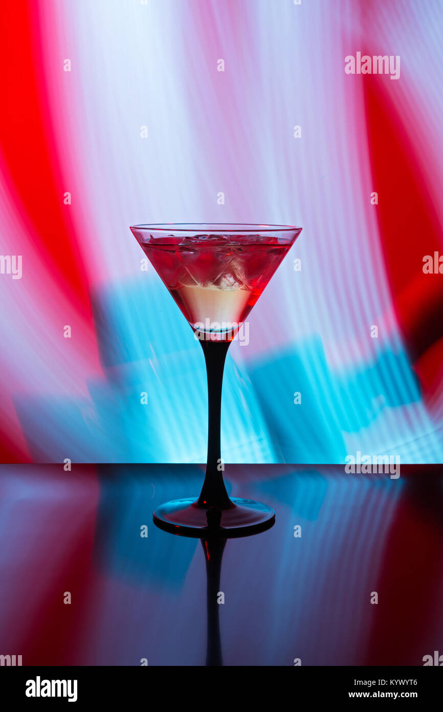 Martini glass with ice against bright abstract light patterns Stock ...
