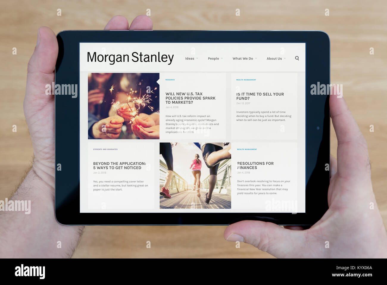 A man looks at the Morgan Stanley website on his iPad tablet device ...
