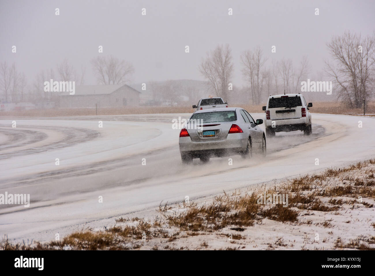 Vehicles traveling on slippery icy road in snow storm Stock Photo - Alamy