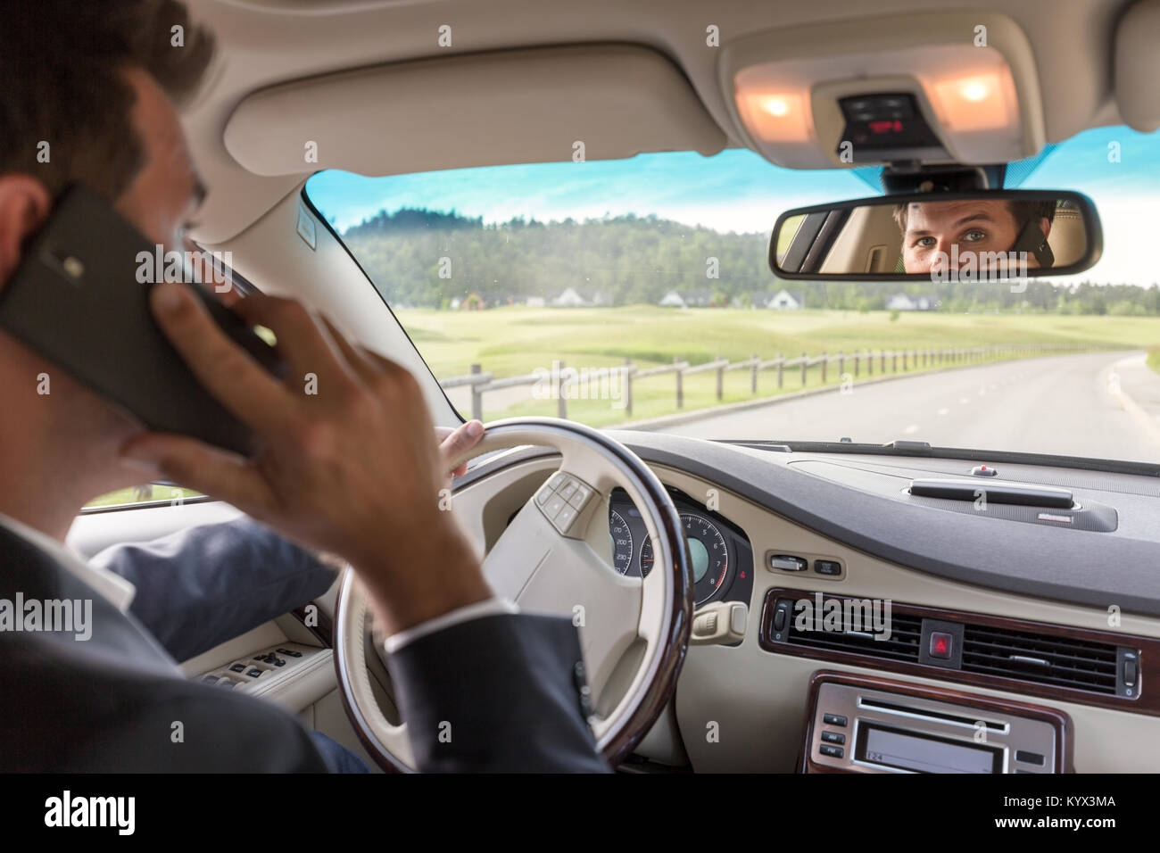 Man talking on cell phone while driving not paying attention to the ...