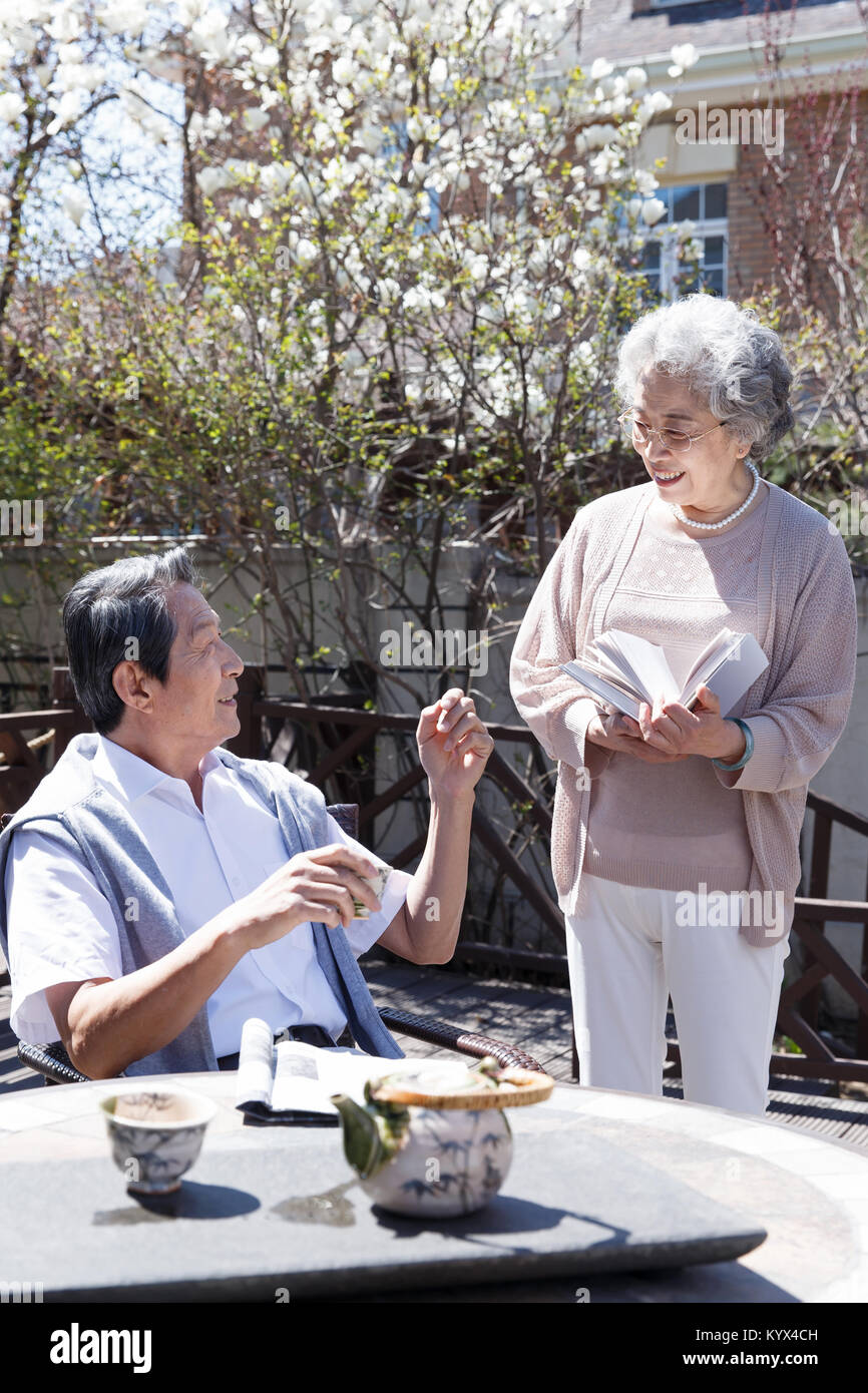 The old couple read in the courtyard Stock Photo - Alamy