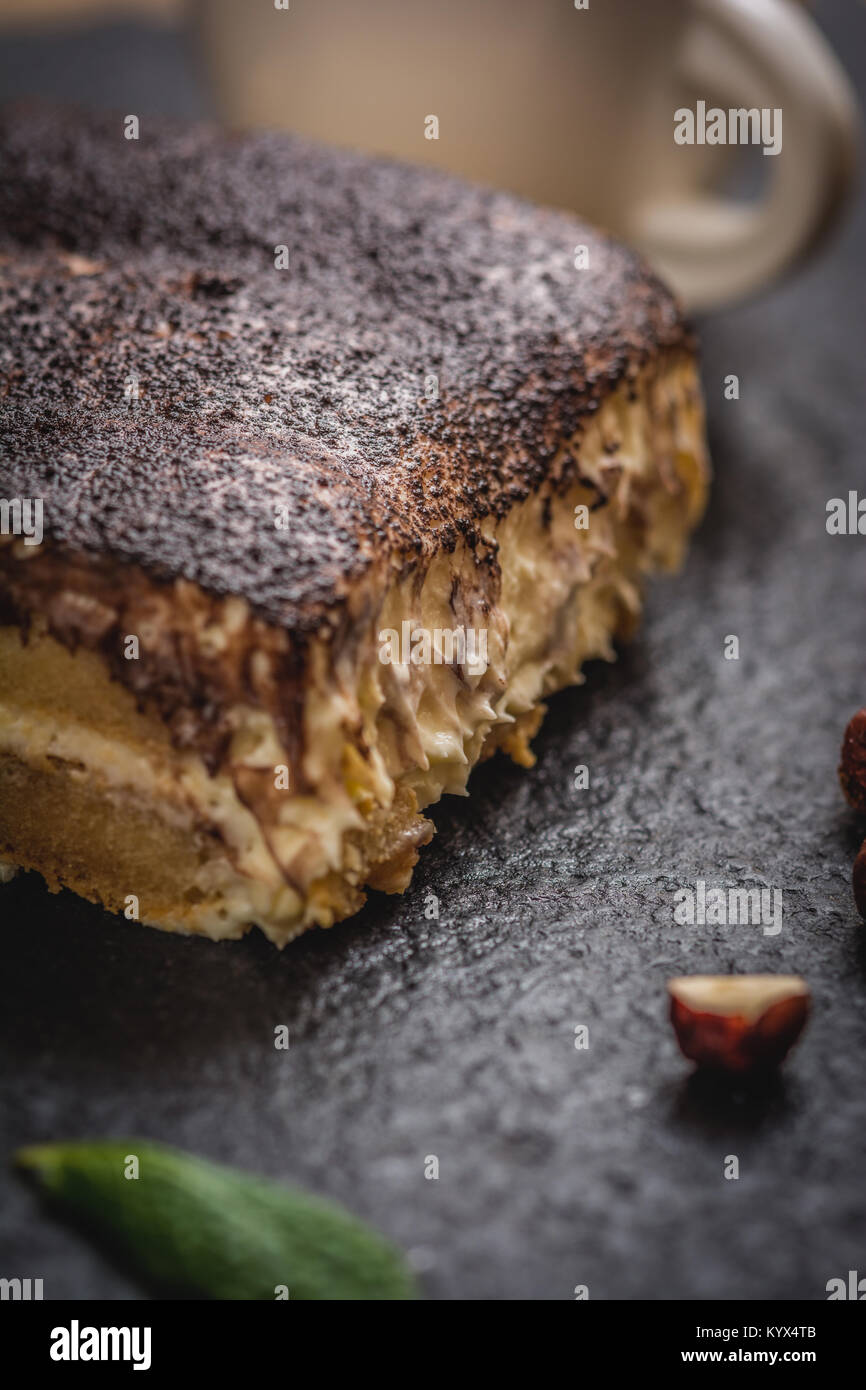 Traditional italian dessert tiramisu on black stone table Stock Photo ...