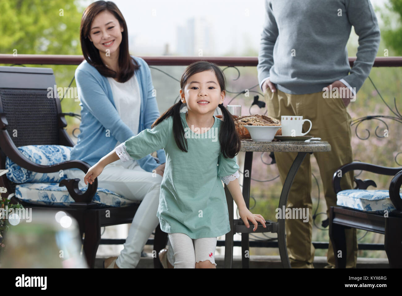 Happy families eat breakfast on the terrace Stock Photo - Alamy