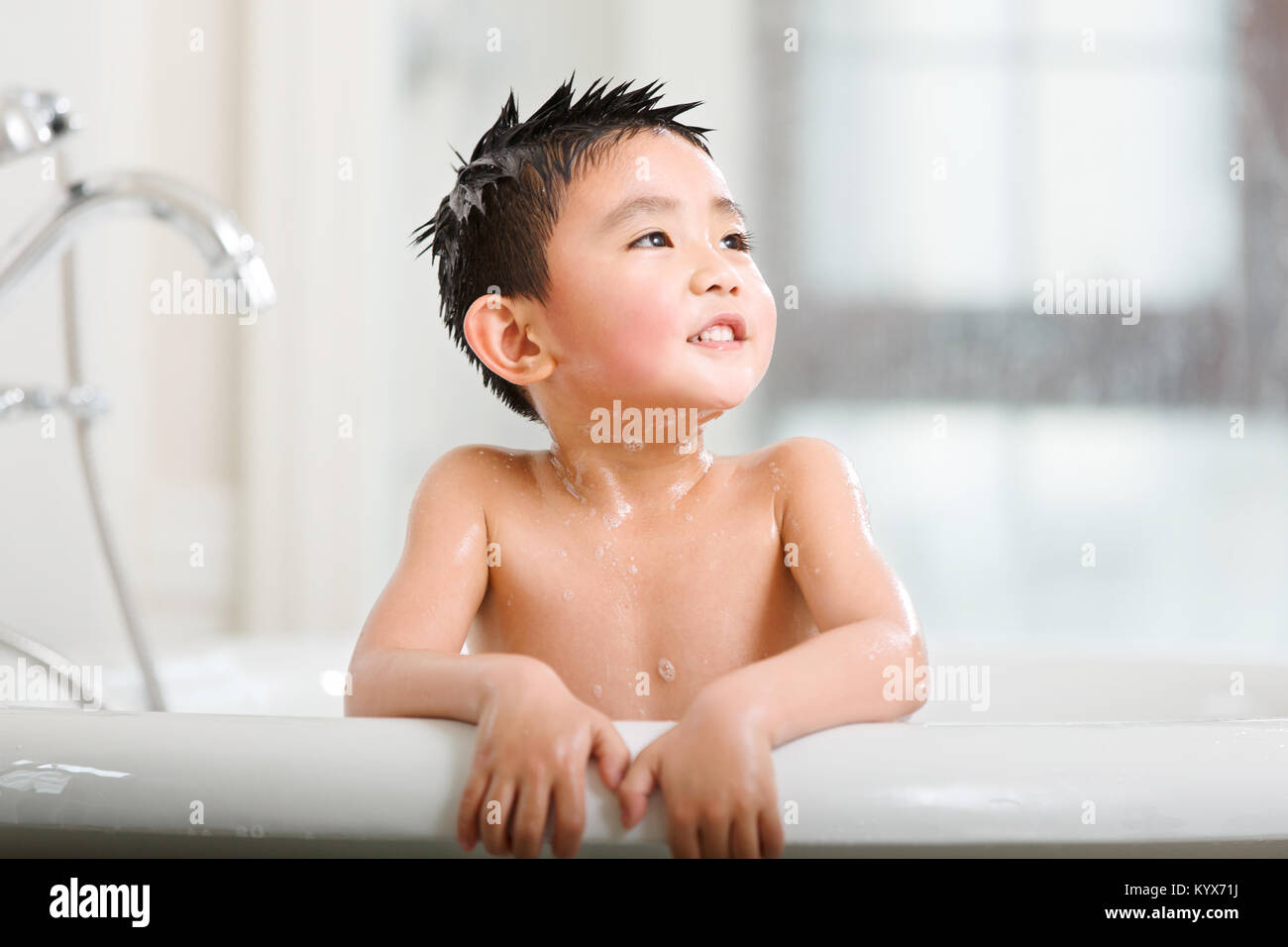 The cute little boy is taking a bath Stock Photo - Alamy