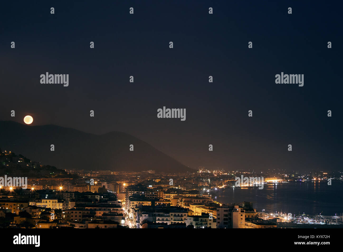 The night panorama of Italian city Salerno. The moon rising from behind ...