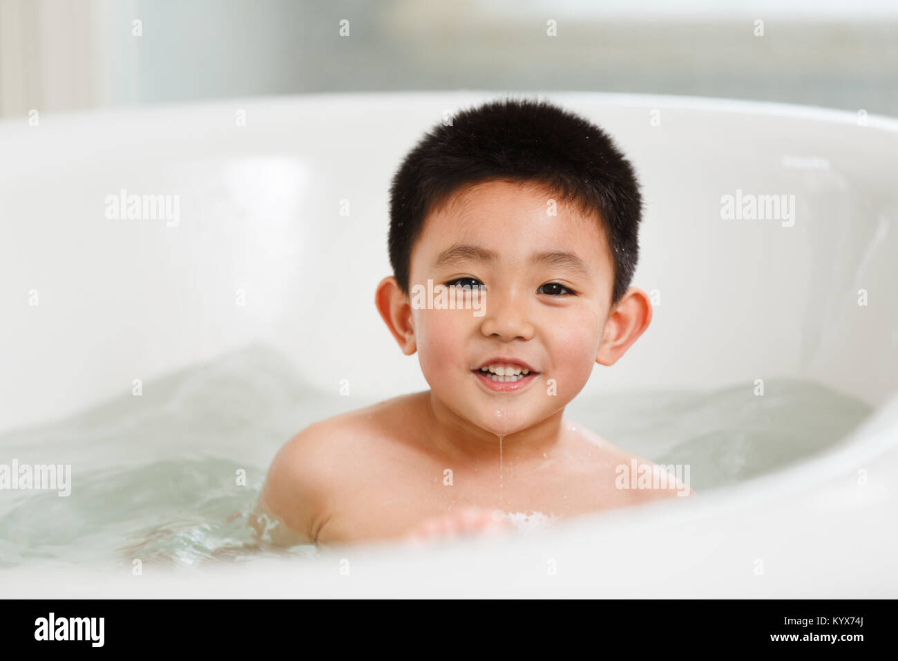 The cute little boy is taking a bath Stock Photo - Alamy