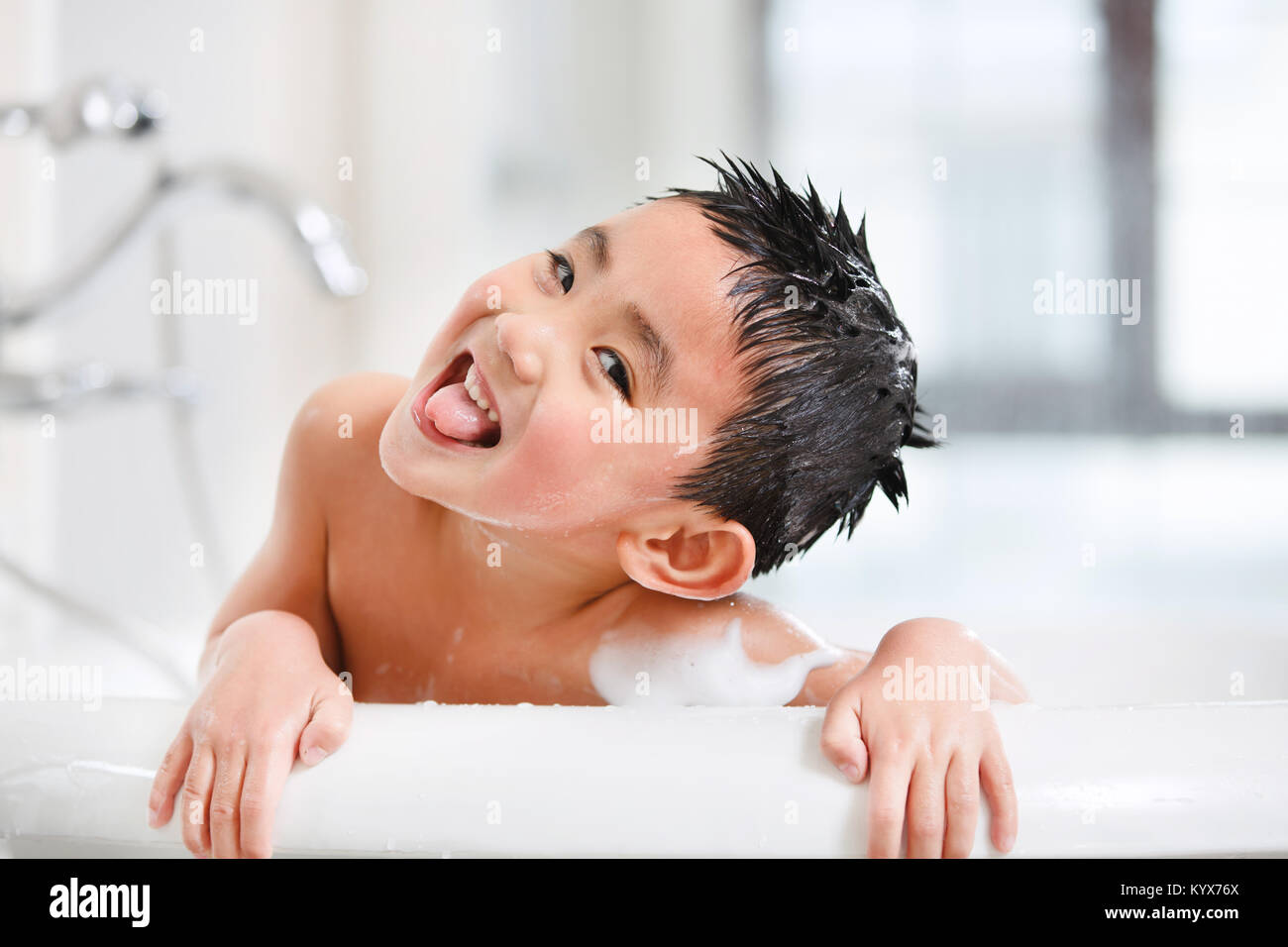 The cute little boy is taking a bath Stock Photo - Alamy
