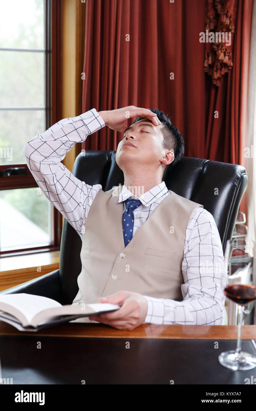 Tired business man in study Stock Photo - Alamy