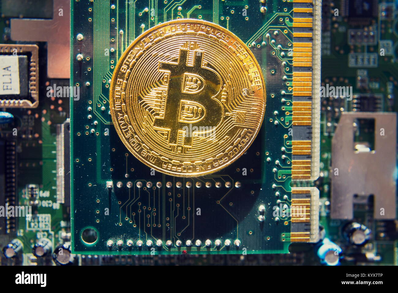 Golden bitcoin coin lying on computer motherboard, cryptocurrency ...