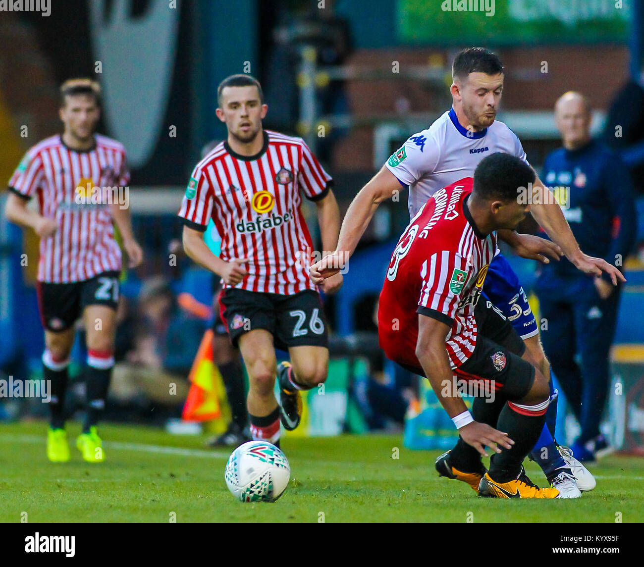 Bury's Harry Bunn holds off the challenge from Sunderland's Tyias ...