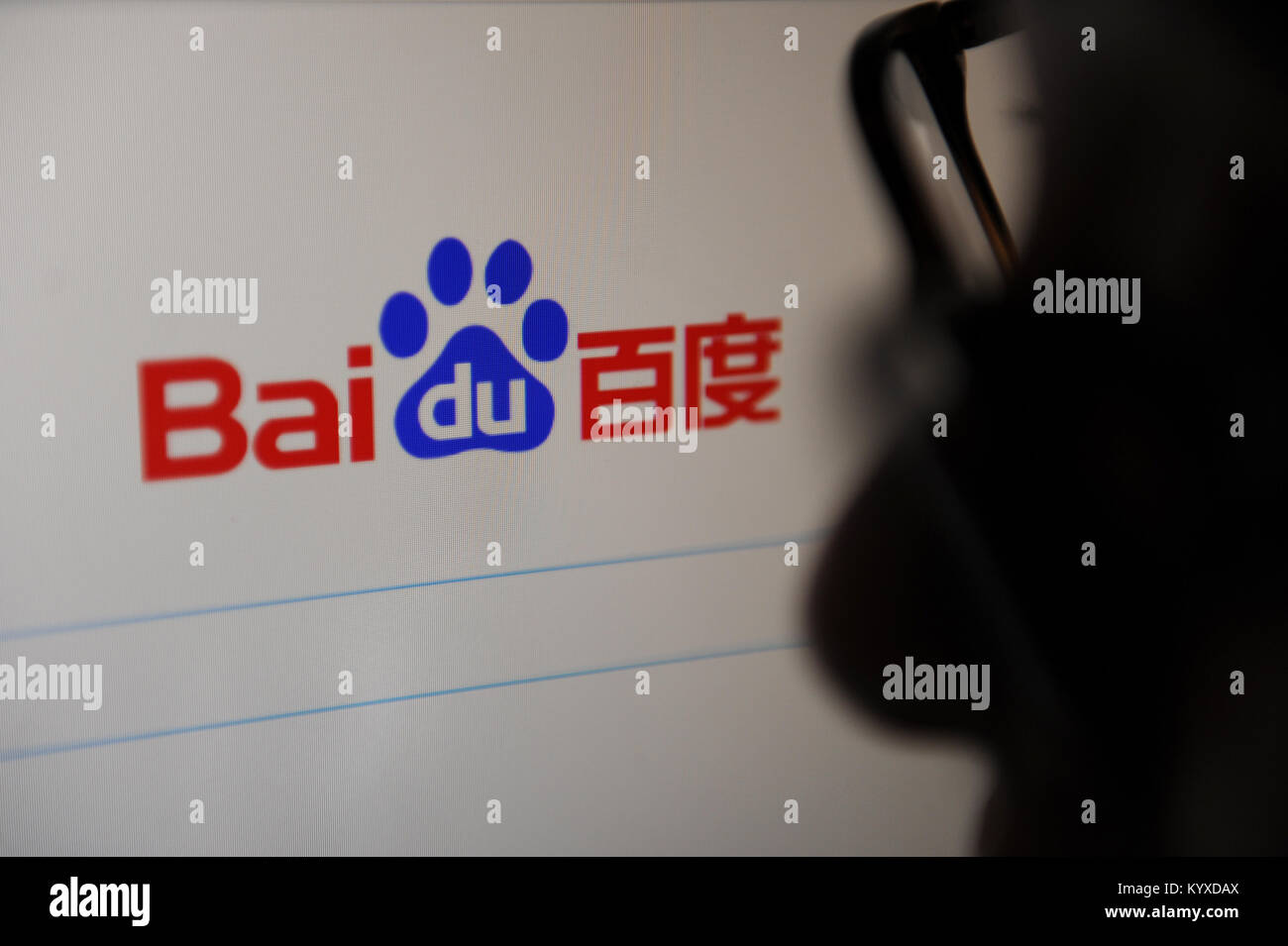 A woman looks at a computer screen which shows the Baidu logo Stock ...