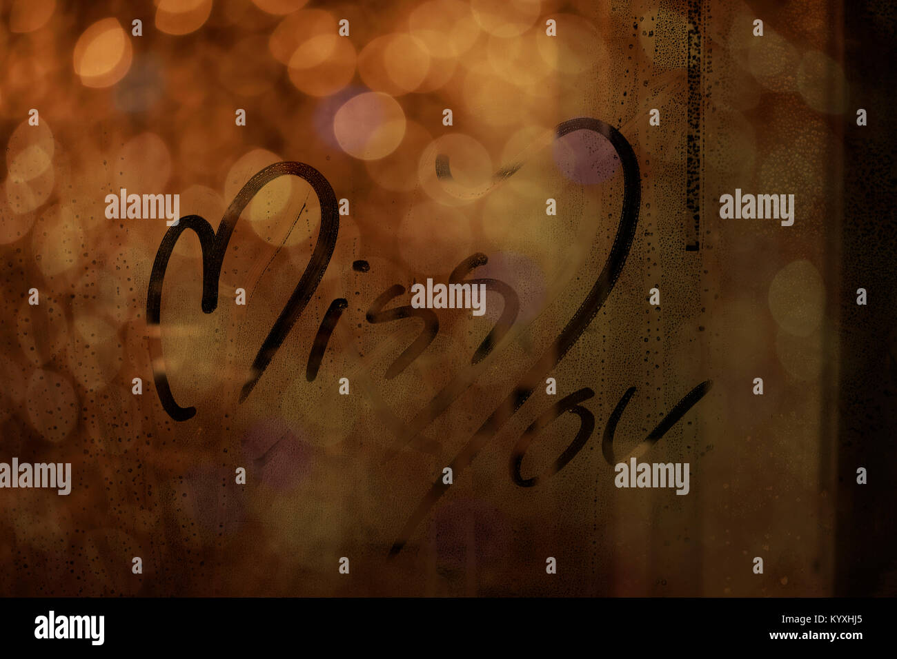 Miss you on the mirror of window or Miss you text draw on droplet ...