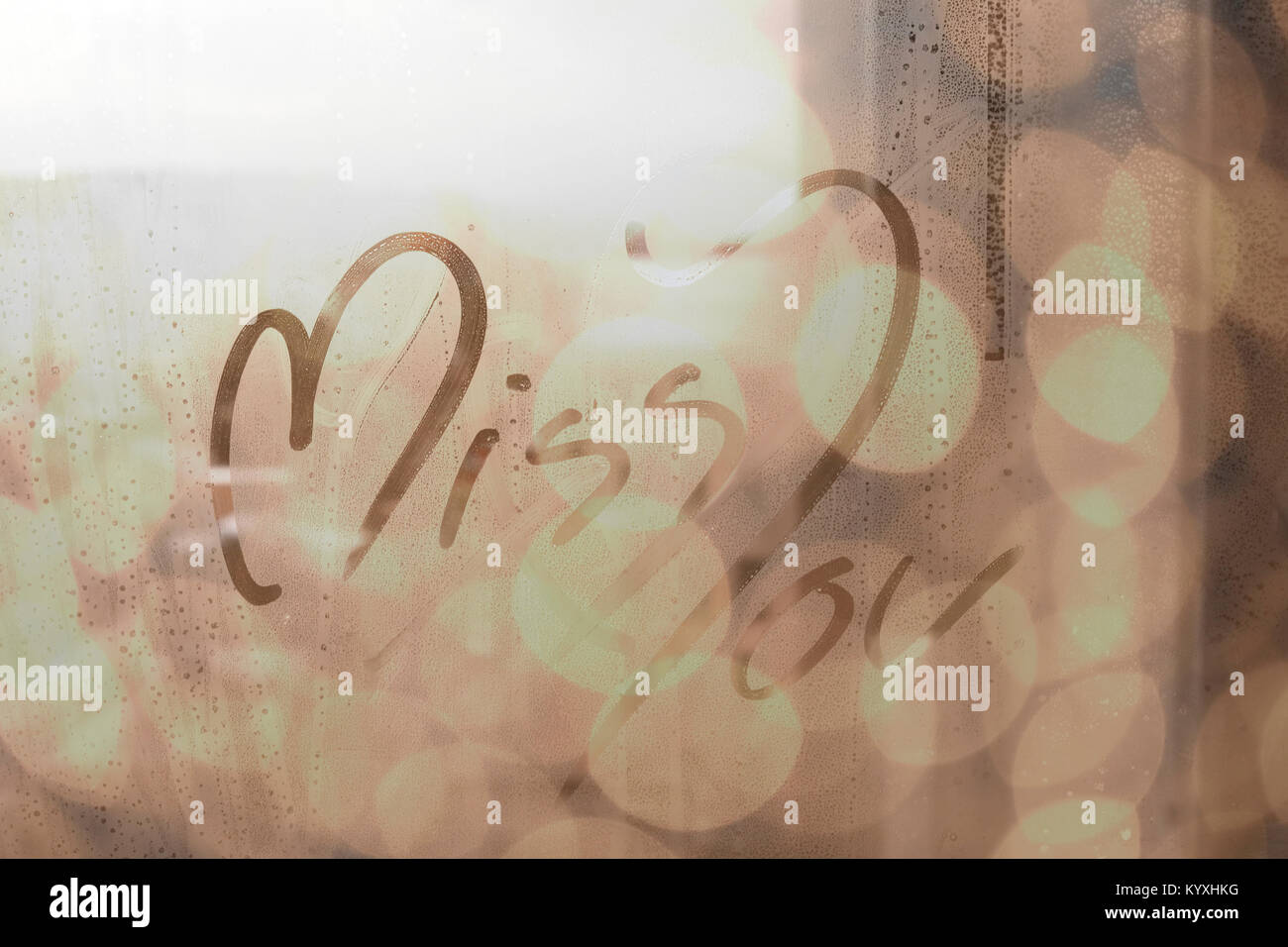 Miss you on the mirror of window or Miss you text draw on droplet ...