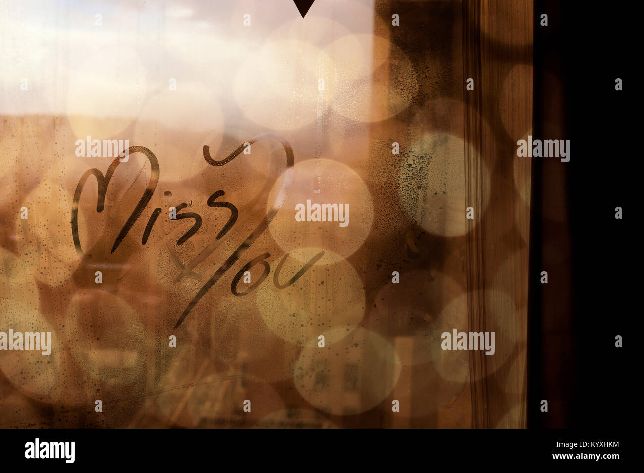 Miss you on the mirror of window or Miss you text draw on droplet ...