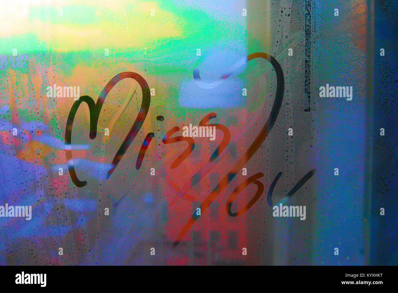 Miss you on the mirror of window or Miss you text draw on droplet ...