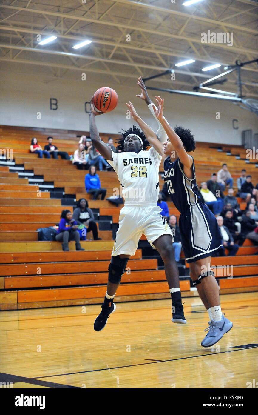 Forward pulling down a rebound off the offensive boards during a high ...