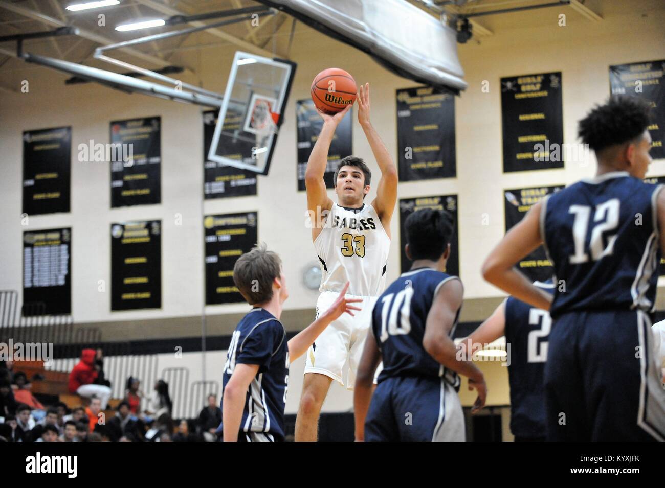 High school player taking a jump shot from three-point range. USA Stock ...