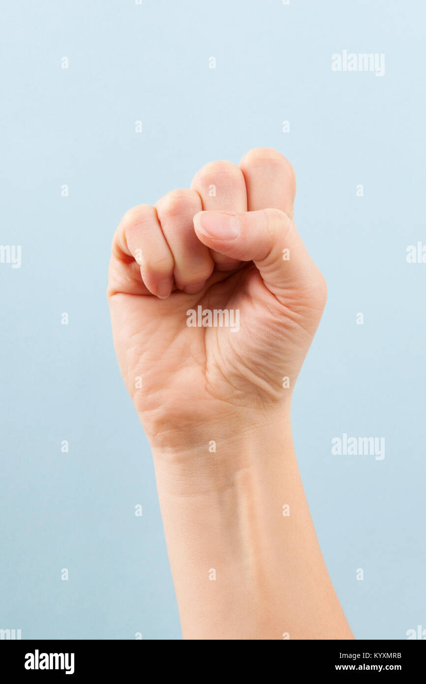 American sign language. Female hand showing letter S isolated on blue ...
