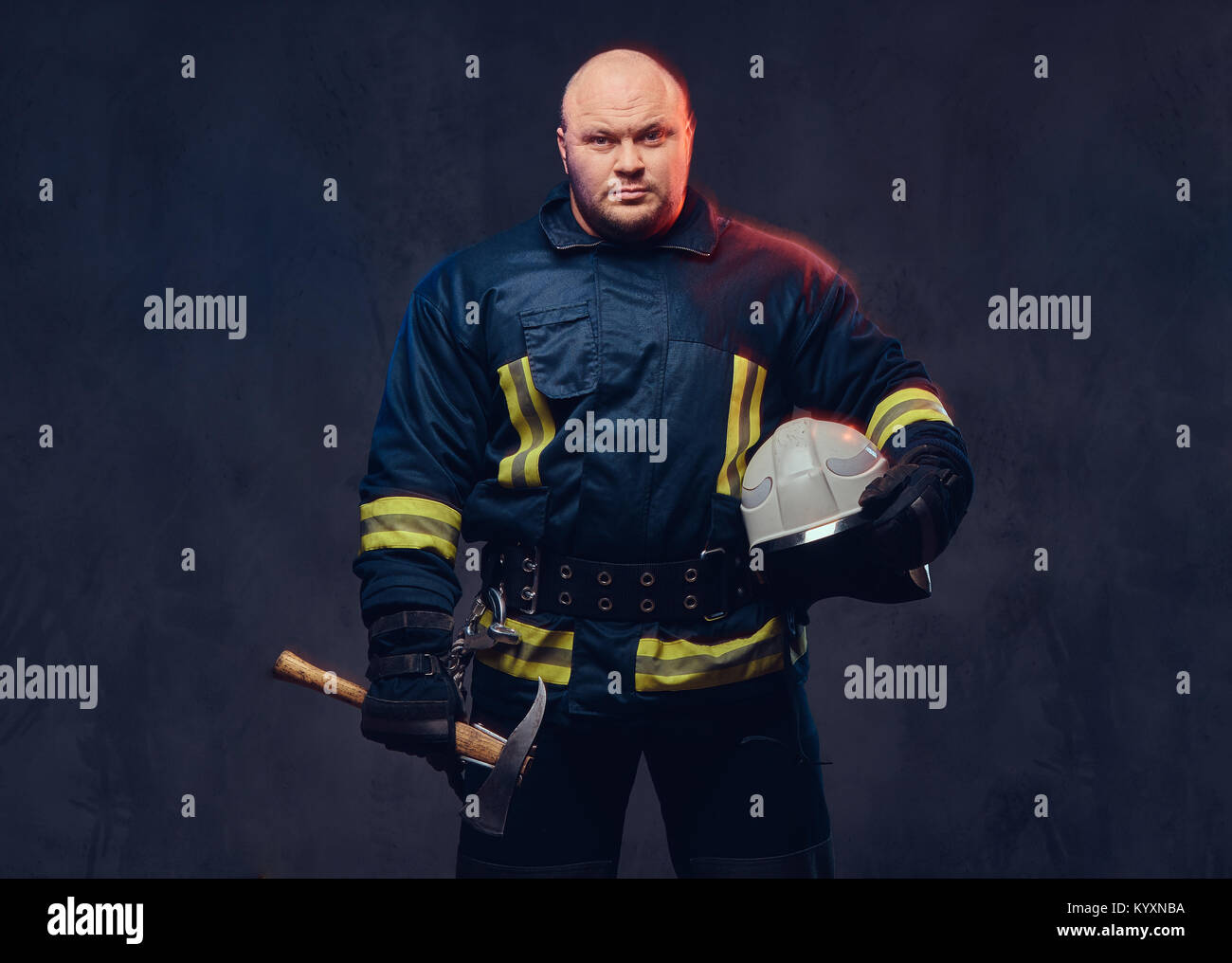 Firefighter holds the axe Stock Photo - Alamy