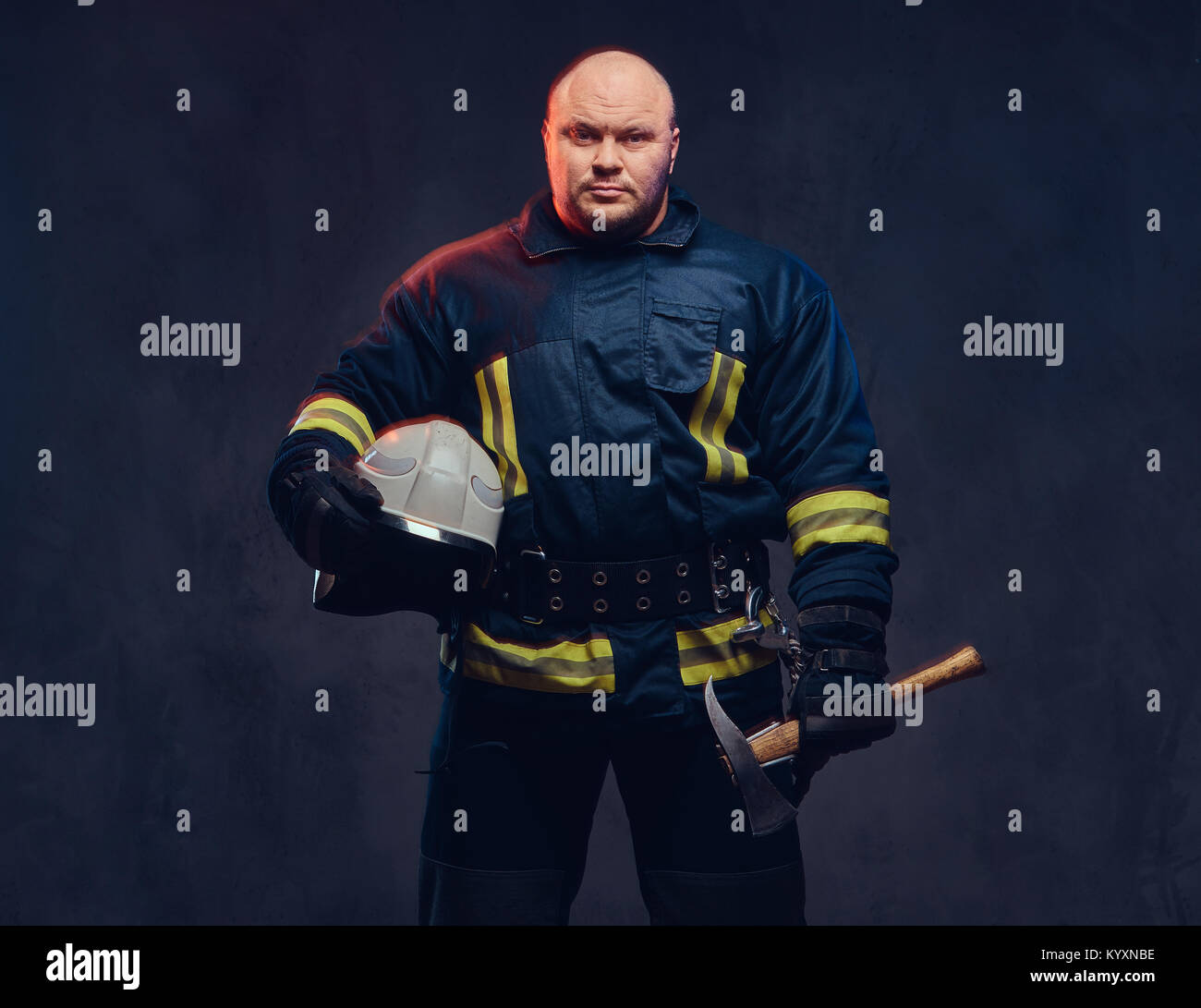 Firefighter holds the axe Stock Photo - Alamy