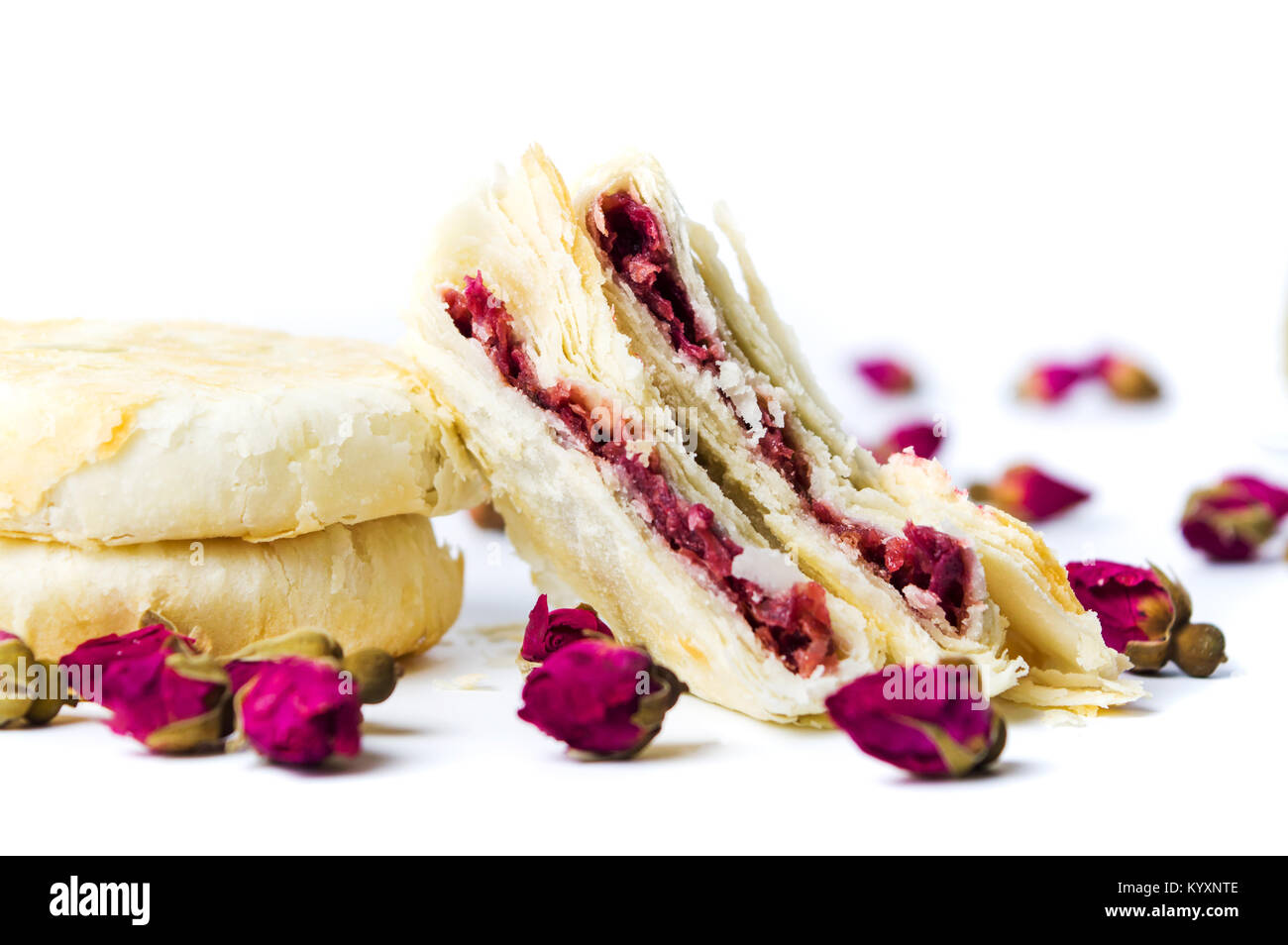 Rose pastry with natural flowers tea on white background Stock Photo ...