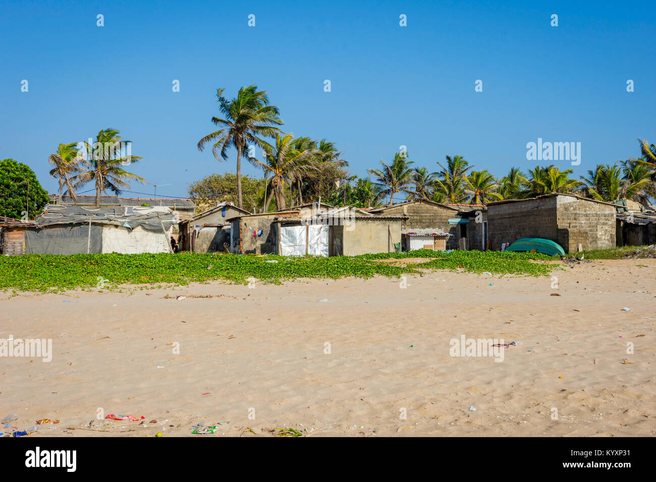 Sandy beach with small local houses in Colombo, Sri Lanka Stock Photo ...