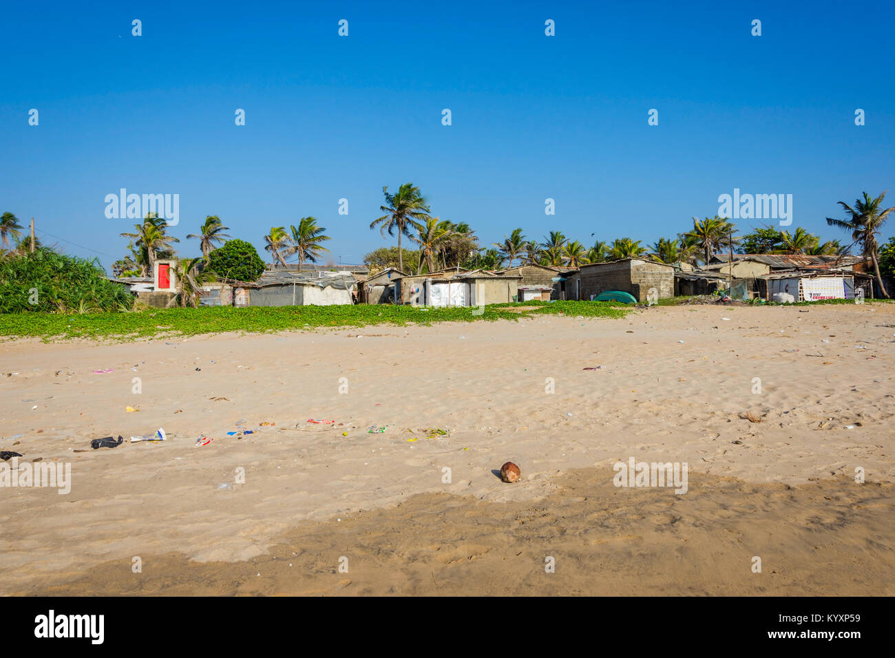 Sandy beach with small local houses in Colombo, Sri Lanka Stock Photo ...
