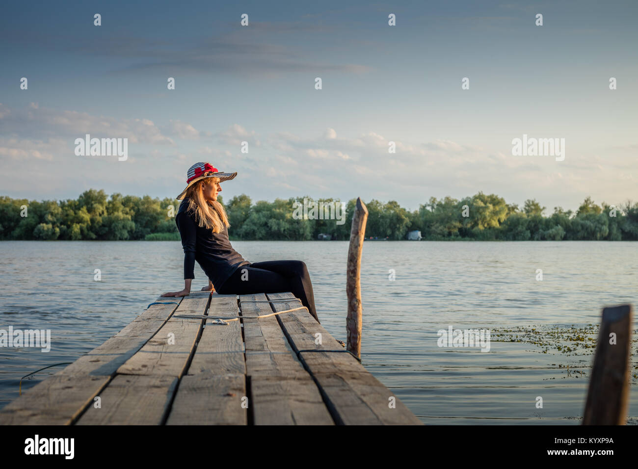 young beautiful girl on pontoon enjoying the river Stock Photo - Alamy