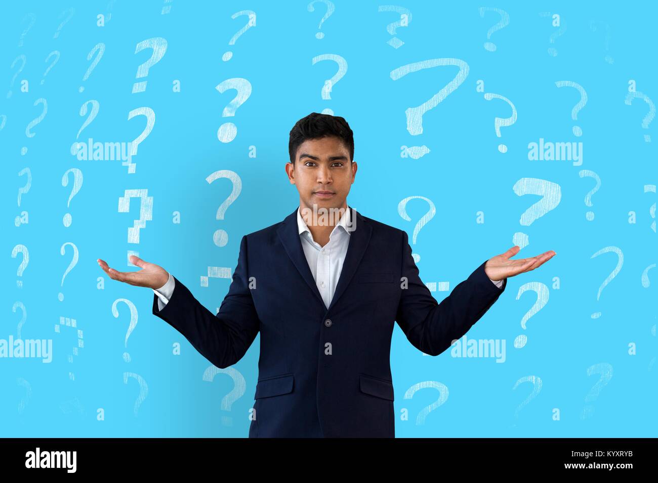 Man shrugging in front of a blue background with question marks pattern ...