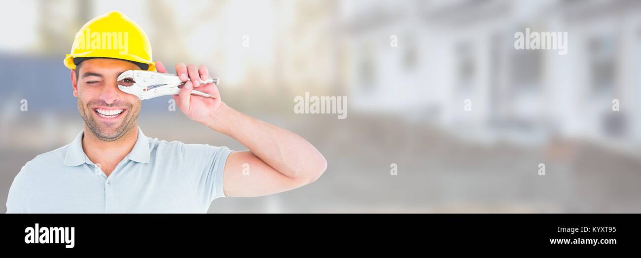 Construction Worker on building site holding wrench Stock Photo - Alamy