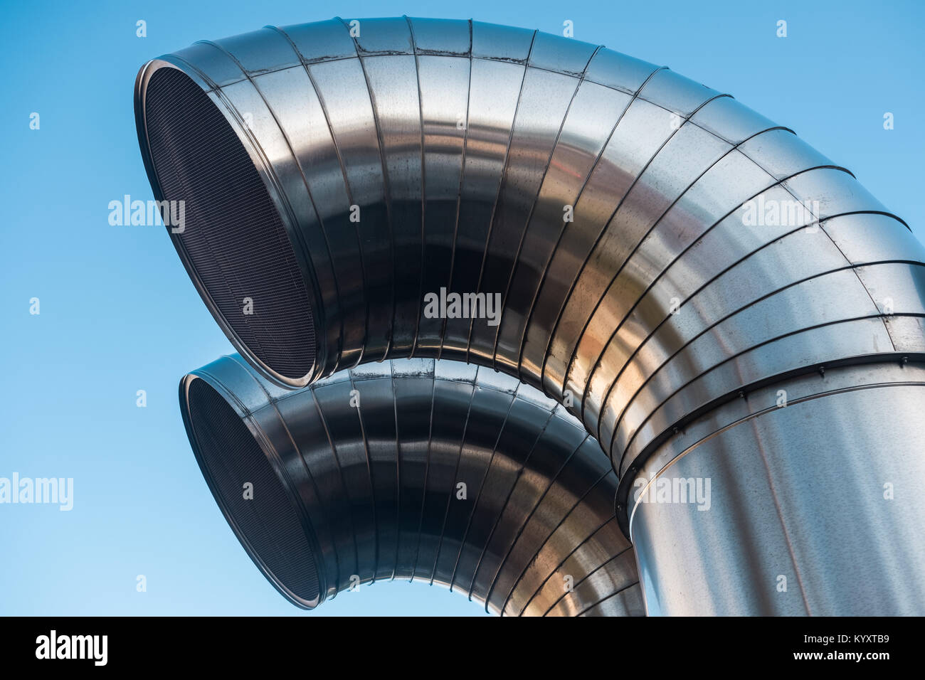 Funnel ventilation ducts on a modern building, blue sky Stock Photo - Alamy