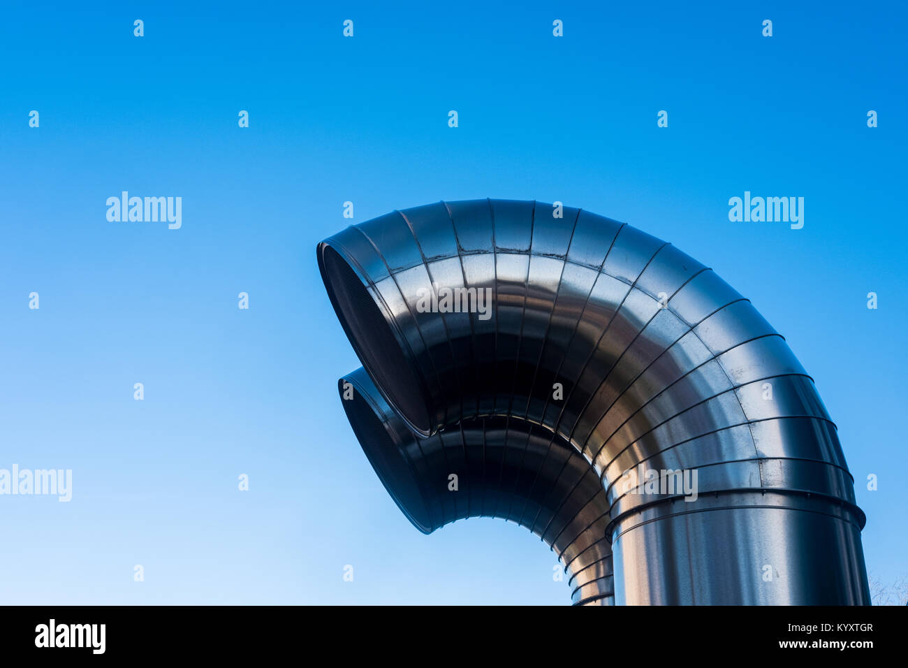 Funnel ventilation ducts on a modern building, blue sky Stock Photo - Alamy
