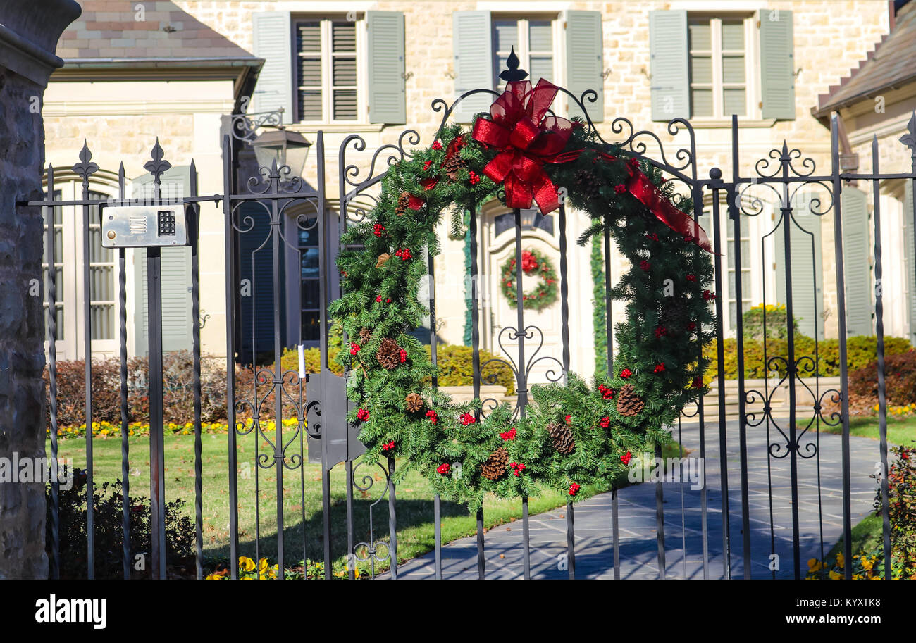 Christmas wreath on Gate framing matching door wreath in distance at ...