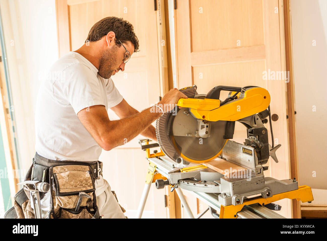 A man cutting a piece of wood with a circular saw / radial saw Stock ...