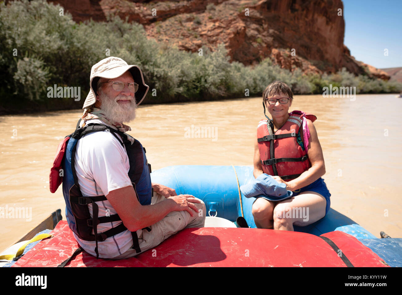 Portrait of senior man and woman sitting in inflatable raft on San Juan ...