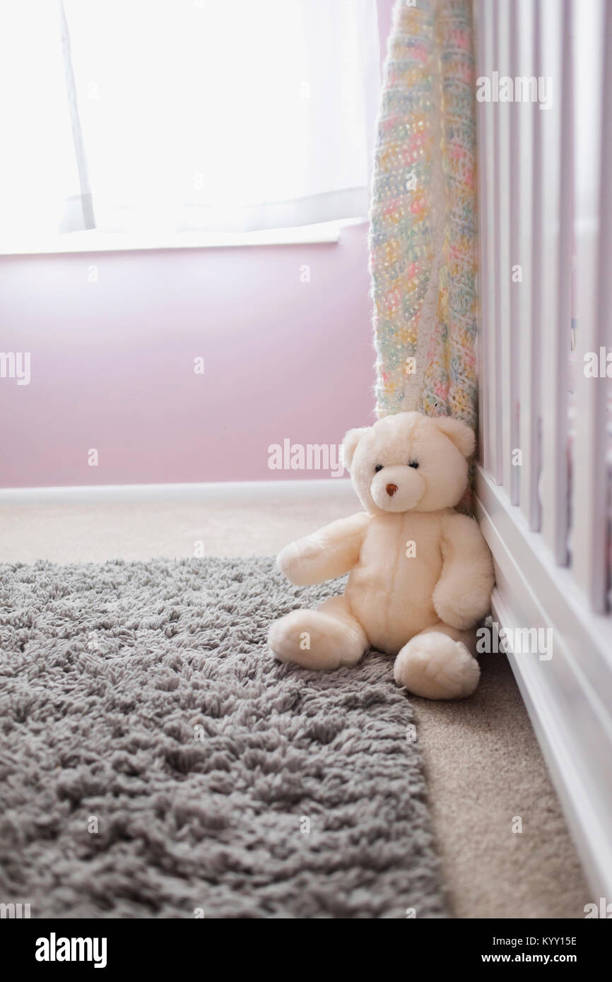 Teddy bear on carpet at home Stock Photo - Alamy