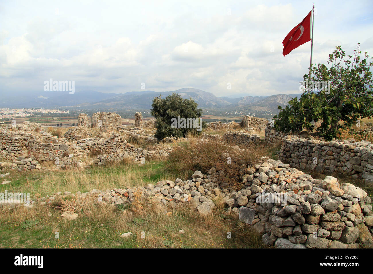 Red turkish flag and ruins of fortress near Milas, Turkey Stock Photo ...