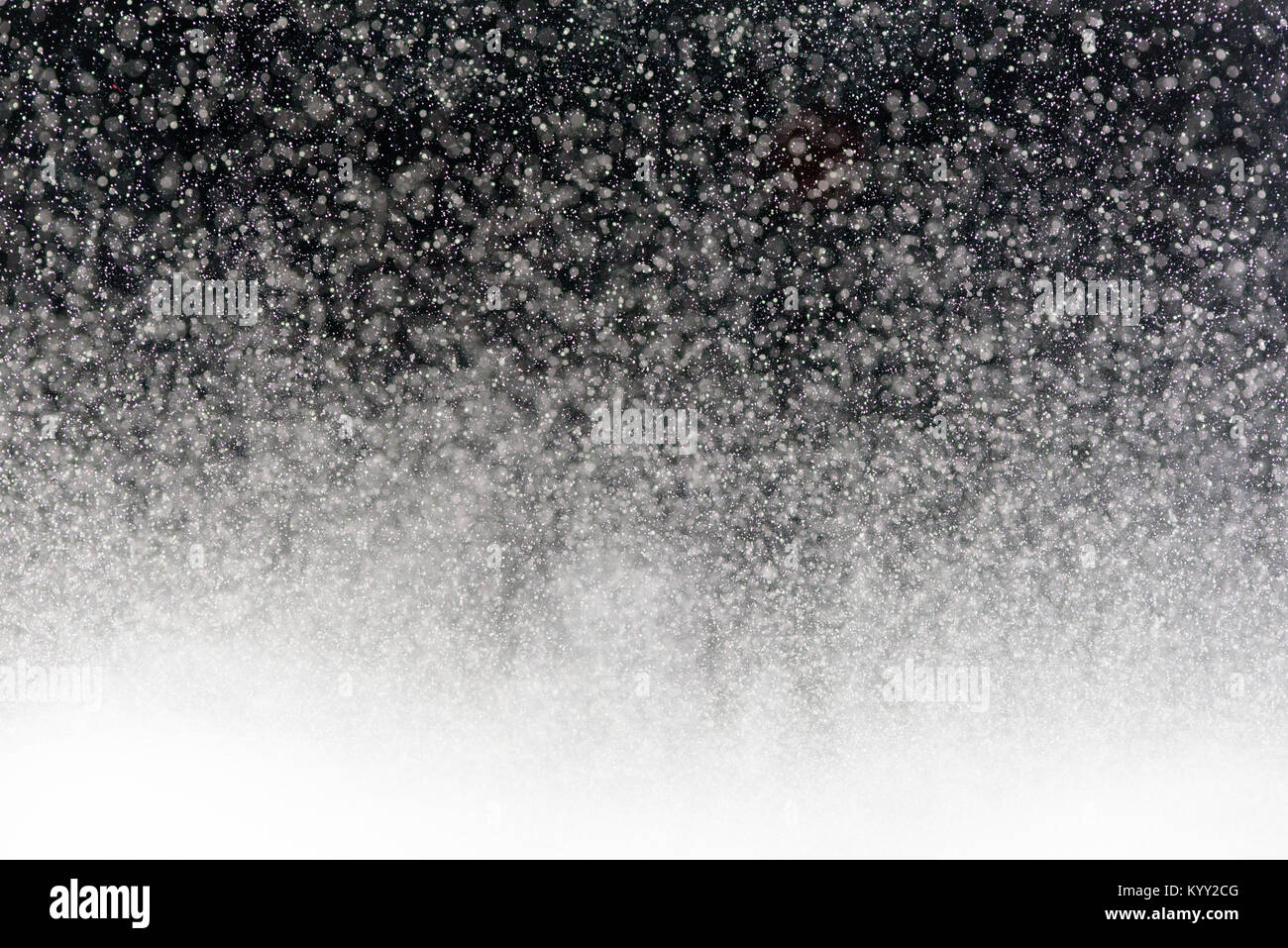 White snow like particles similar to a snowstorm creates a bokeh ...