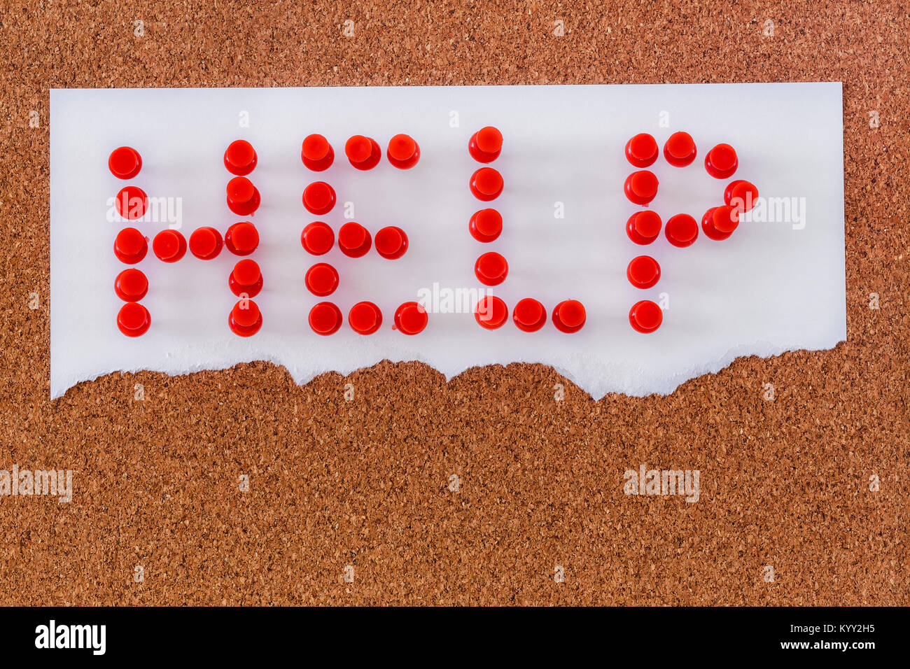 Plastic pins form into Help word on blank notepad Stock Photo - Alamy