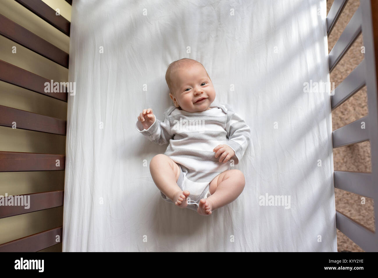 Overhead portrait of baby boy in crib at home Stock Photo - Alamy