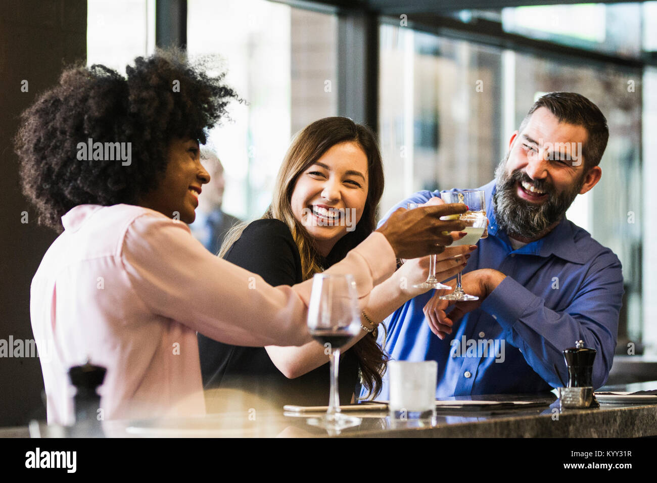 Cheerful business people toasting drinks in hotel Stock Photo - Alamy