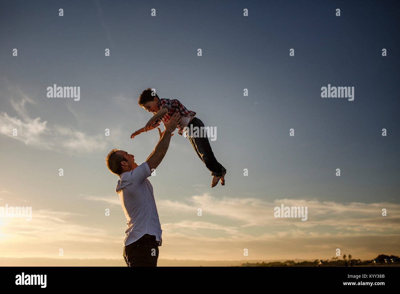 Father throwing son in air at beach hi-res stock photography and images ...