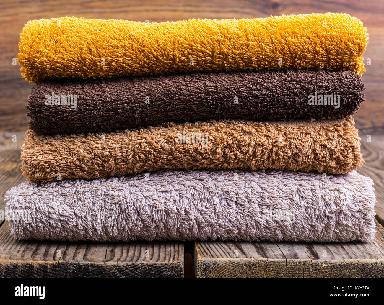 Stack of terry towels on wooden table. Studio Photo Stock Photo - Alamy