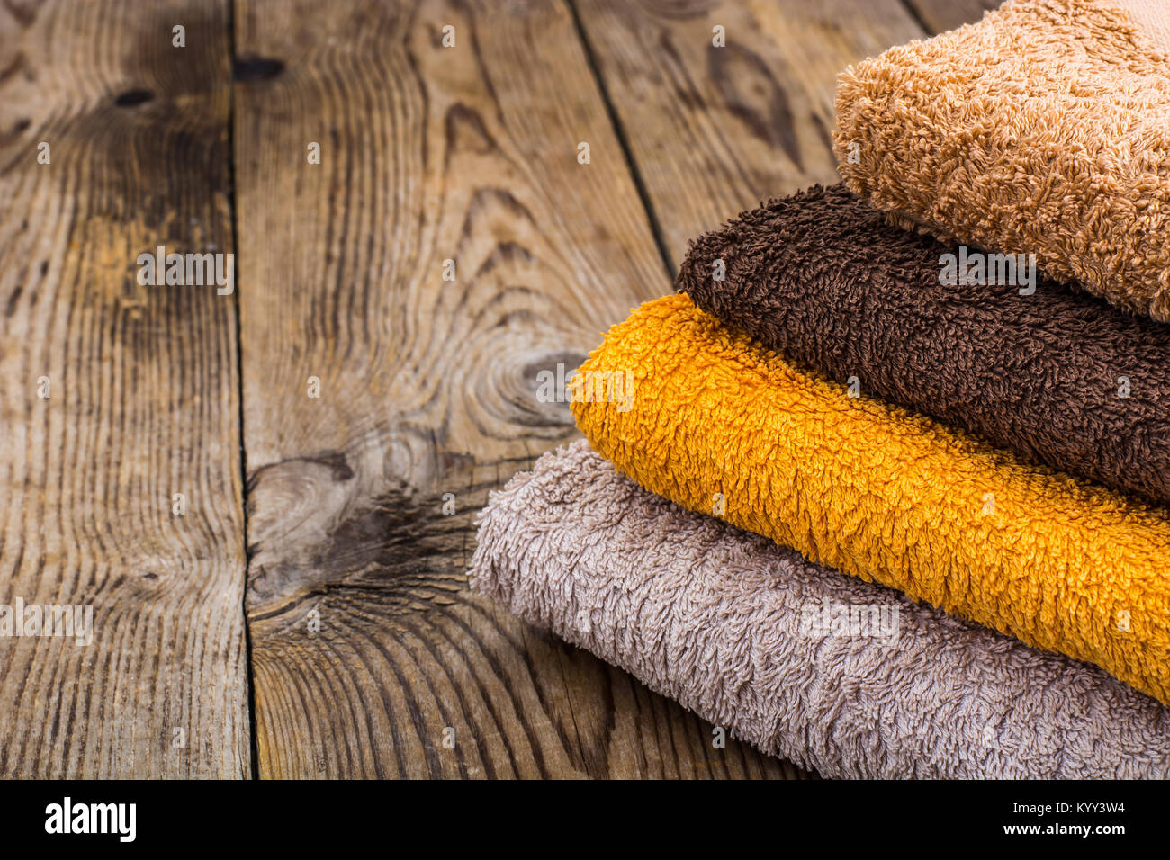 Stack of terry towels on wooden table. Studio Photo Stock Photo - Alamy