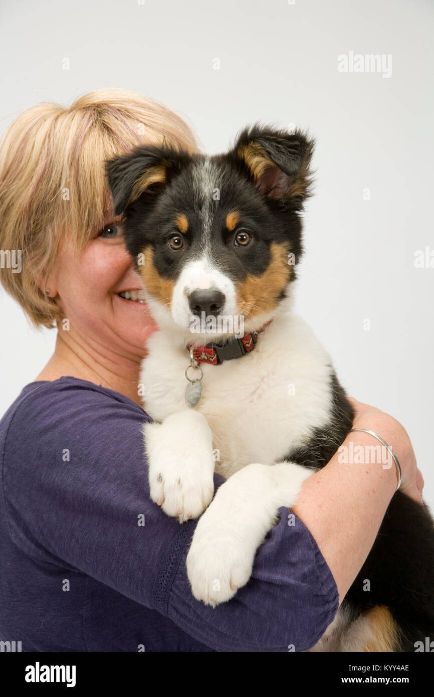 Lady dog owner happily cuddles her new puppy Stock Photo - Alamy
