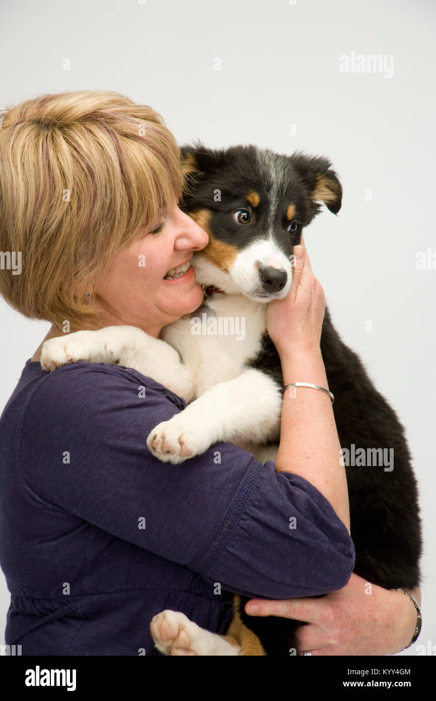 Lady dog owner happily cuddles her new puppy Stock Photo - Alamy