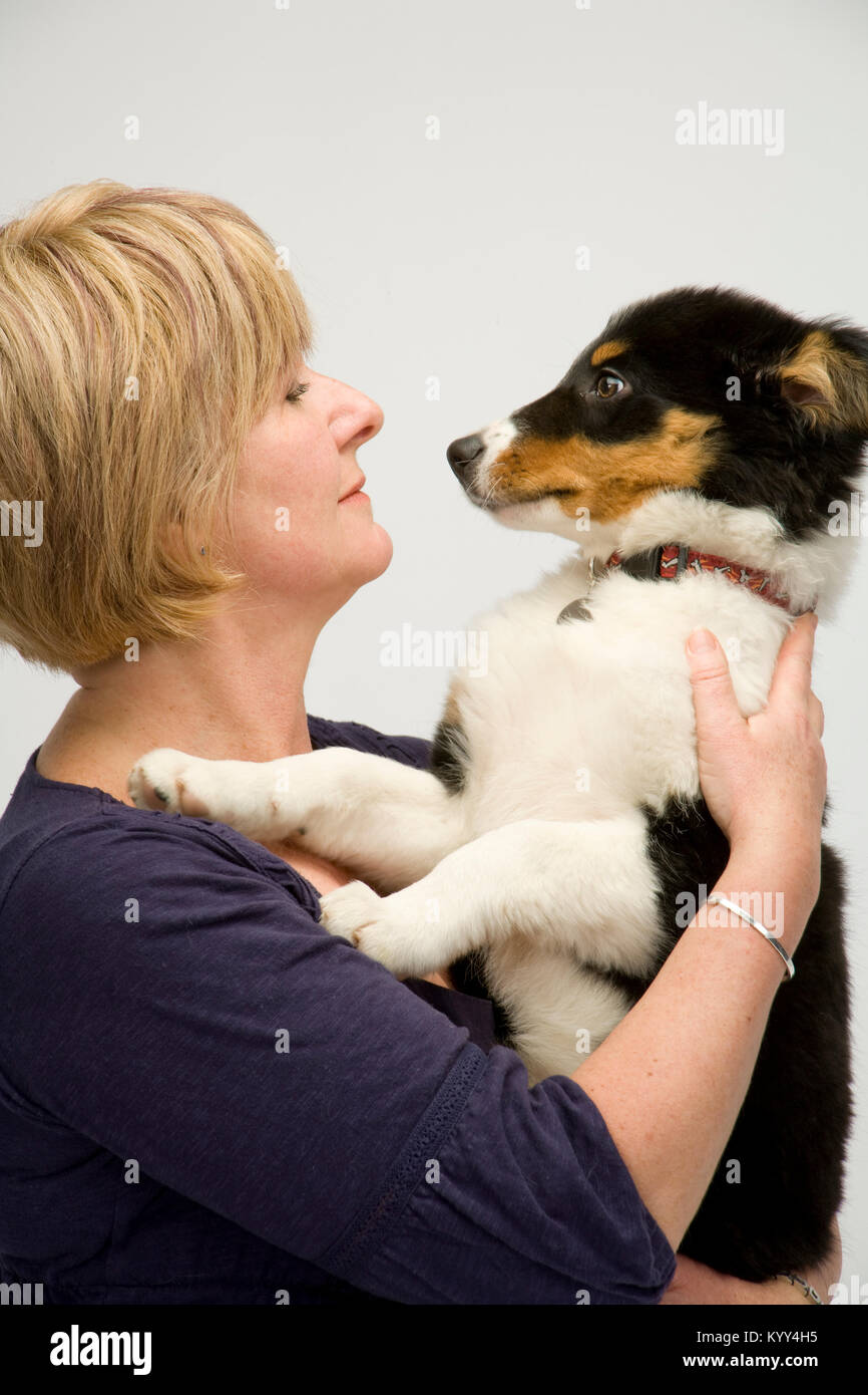 Lady dog owner happily cuddles her new puppy Stock Photo - Alamy
