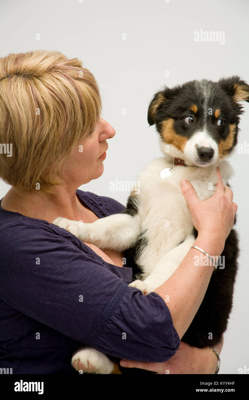 Lady dog owner happily cuddles her new puppy Stock Photo - Alamy
